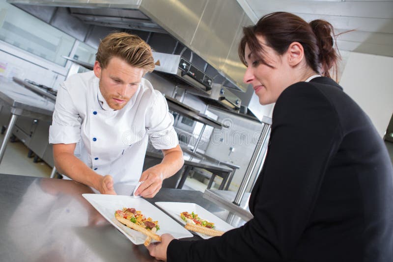 Chef Handing Dinner Plate through Order Station Stock Image - Image of ...