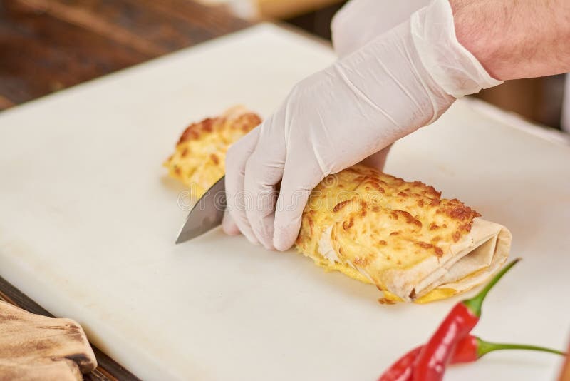 Chef Hands Cutting Burrito on Pieces. Stock Photo - Image of burrito ...