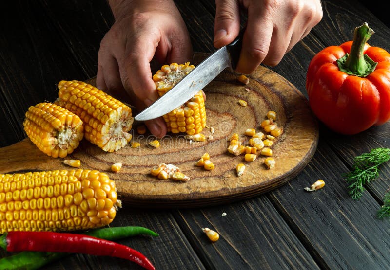 Chef Hands with a Knife Cut Corn. Maize is a Great Diet Breakfast or ...