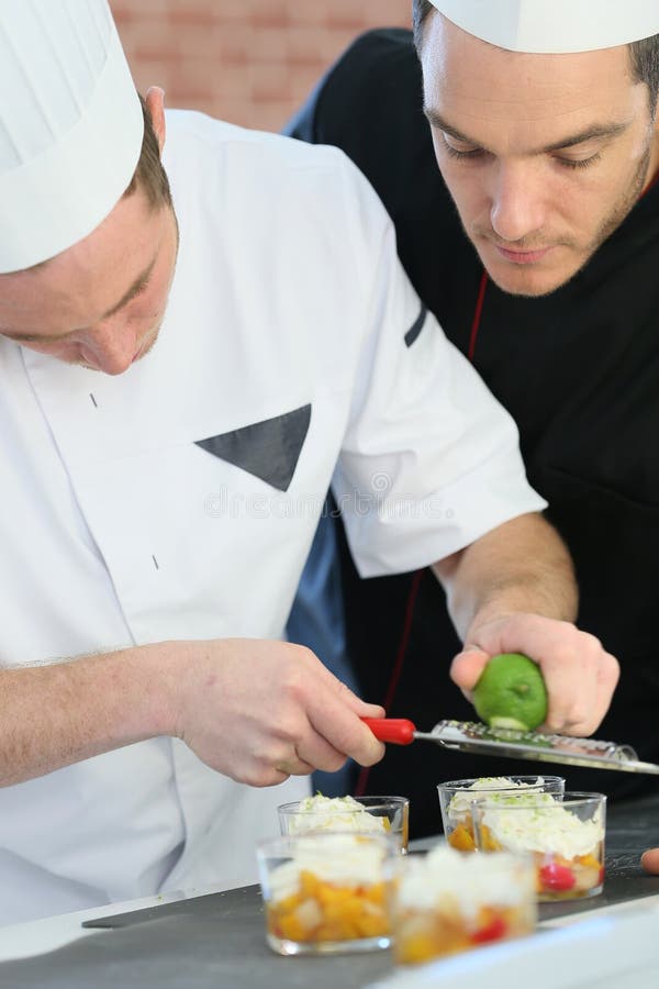 Chef Helping Young Cook To Preparing Dessert Stock Image - Image of ...