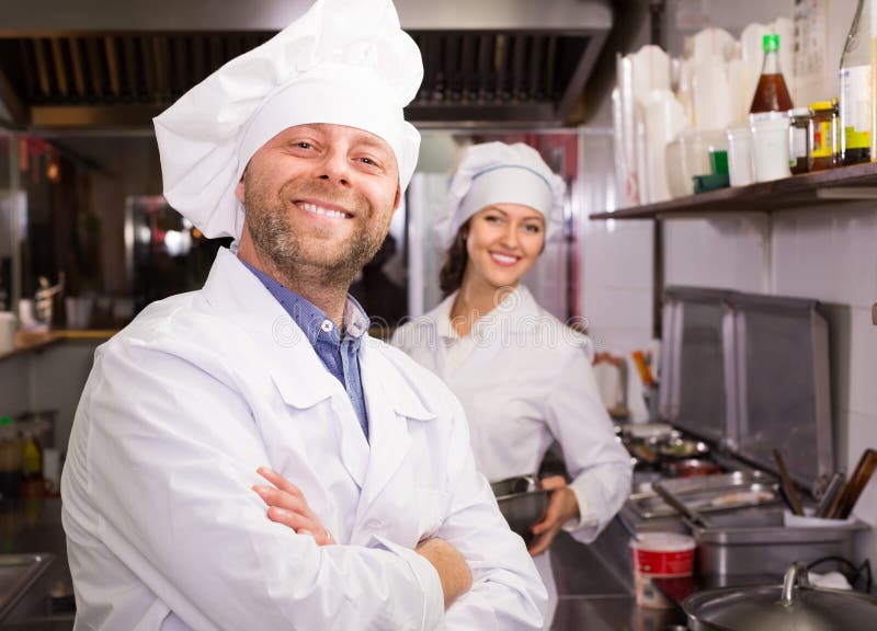Chef and His Helper at Bistro Kitchen Stock Image - Image of adult ...