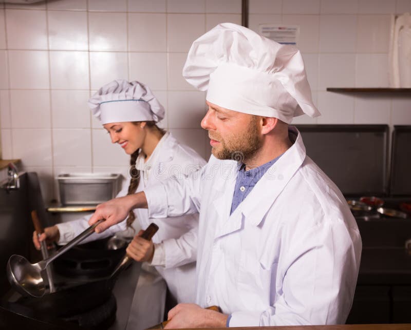 Chef and His Helper at Bistro Kitchen Stock Image - Image of portrait ...