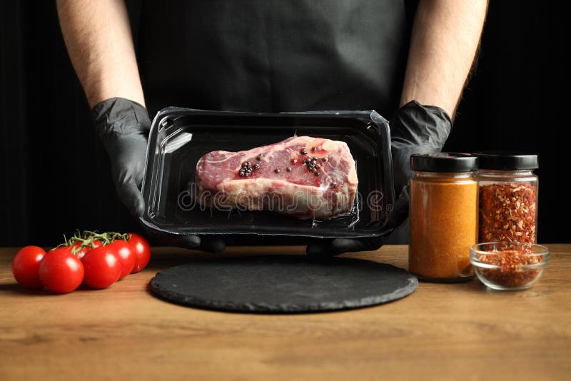 The Chef is Holding a Beef Steak in a Store S Plastic Packaging Stock ...