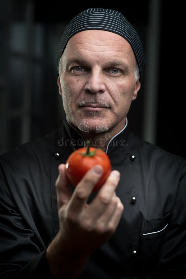 Chef holding a tomato stock image. Image of preparation - 47562517