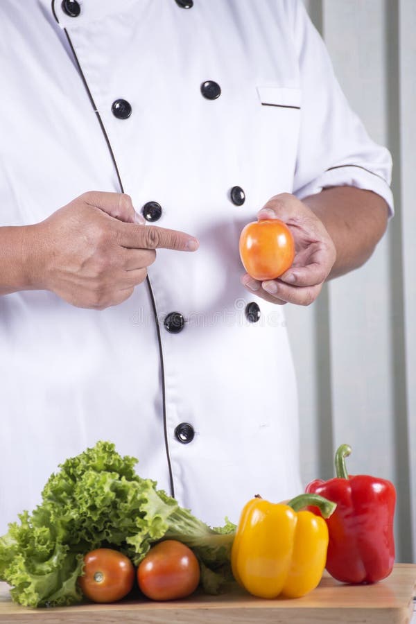 Chef holds Tomato stock photo. Image of design, cook - 47090092