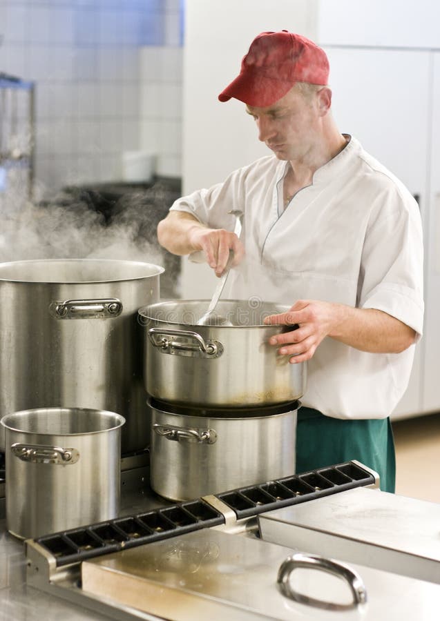 Cook in industrial kitchen stock photo. Image of interior - 34864862