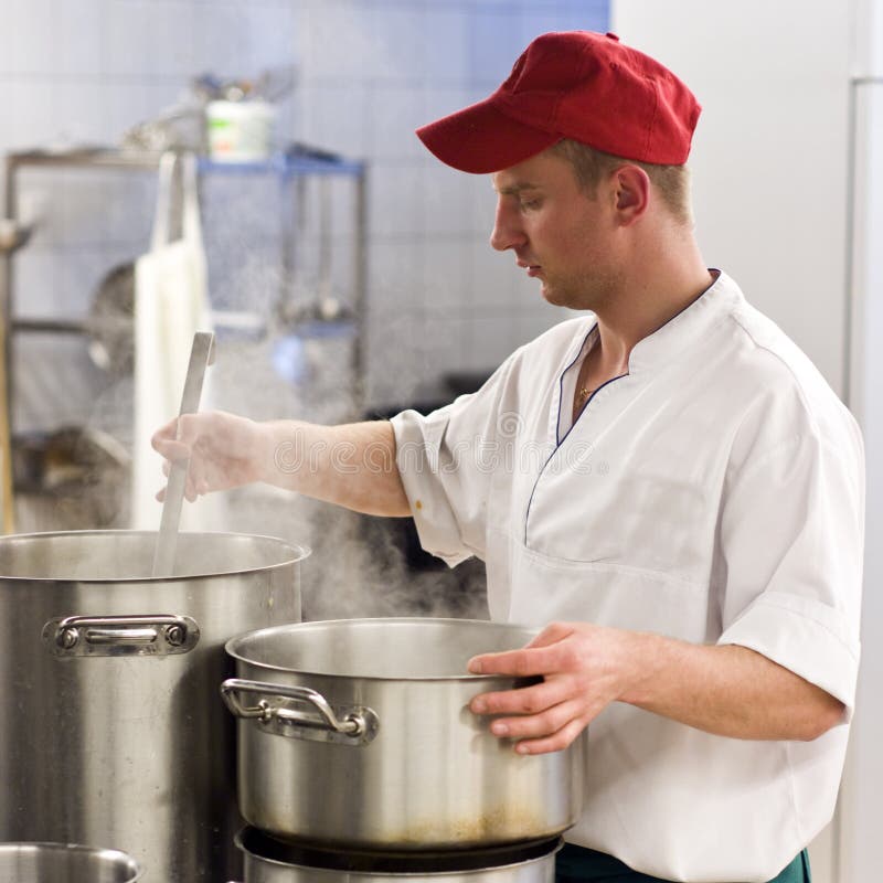Cook in industrial kitchen stock photo. Image of interior - 34864862