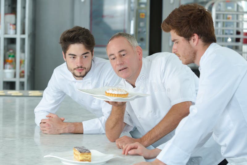 Chef and Interns Looking at Cakes Stock Photo - Image of cake ...