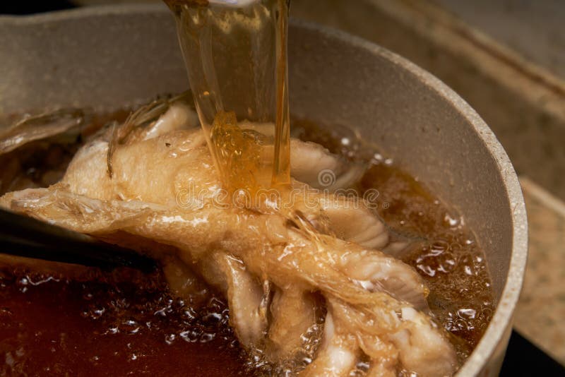 A Chef in the Kitchen is Making Fried Fish, Frying a Whole Fish Stock ...