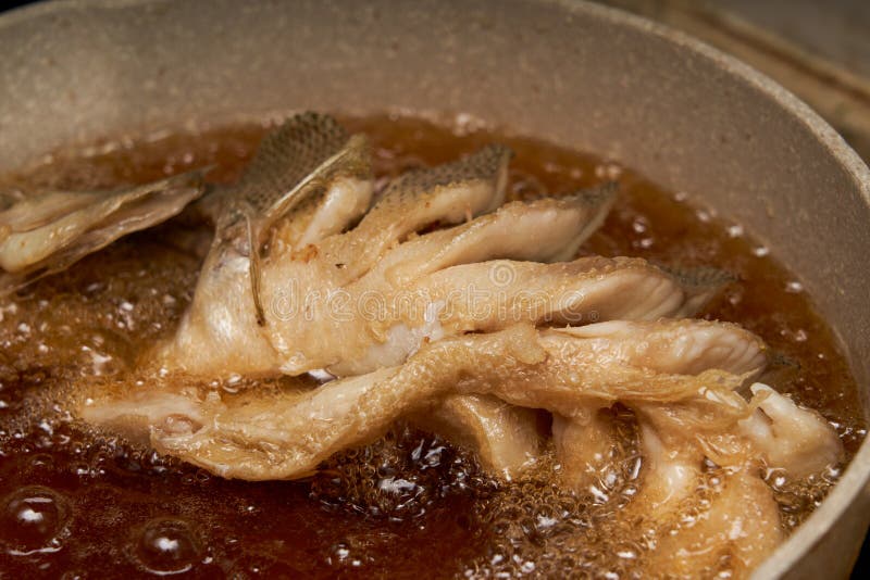 A Chef in the Kitchen is Making Fried Fish, Frying a Whole Fish Stock ...