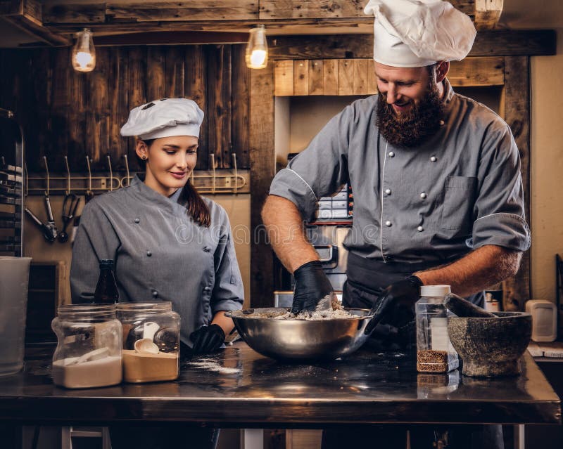 Chef Kneading Dough in the Kitchen. Chef Teaching His Assistant To Bake ...