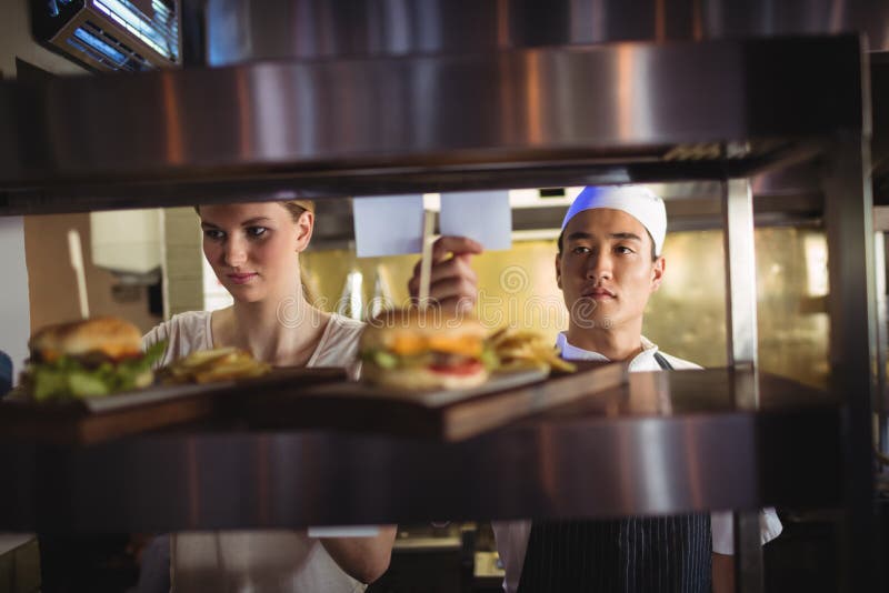 Chef Looking at an Order List in the Commercial Kitchen Stock Photo ...