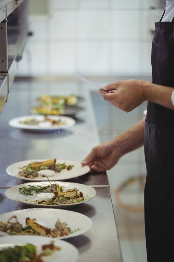 Chef Looking at an Order List in the Commercial Kitchen Stock Image ...