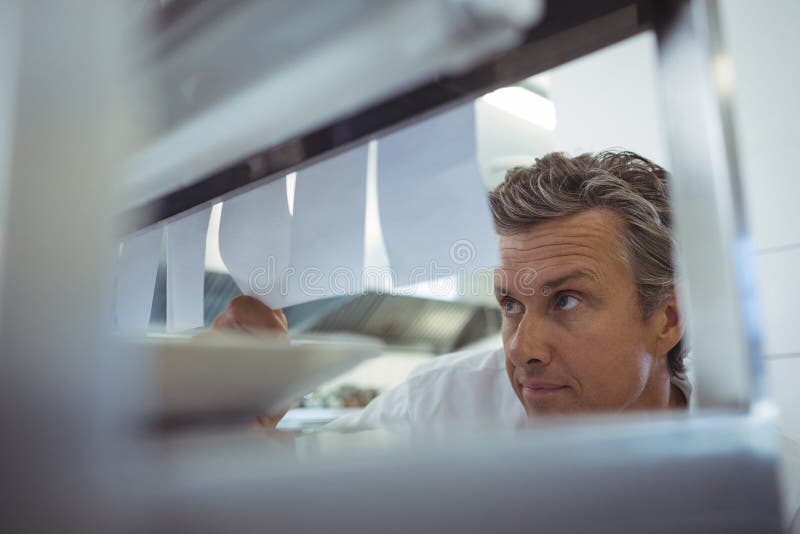 Chef Looking at an Order List in the Commercial Kitchen Stock Photo ...