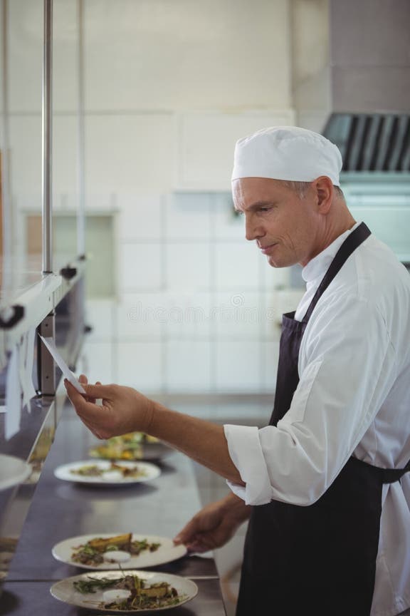Chef Looking at an Order List in the Commercial Kitchen Stock Photo ...