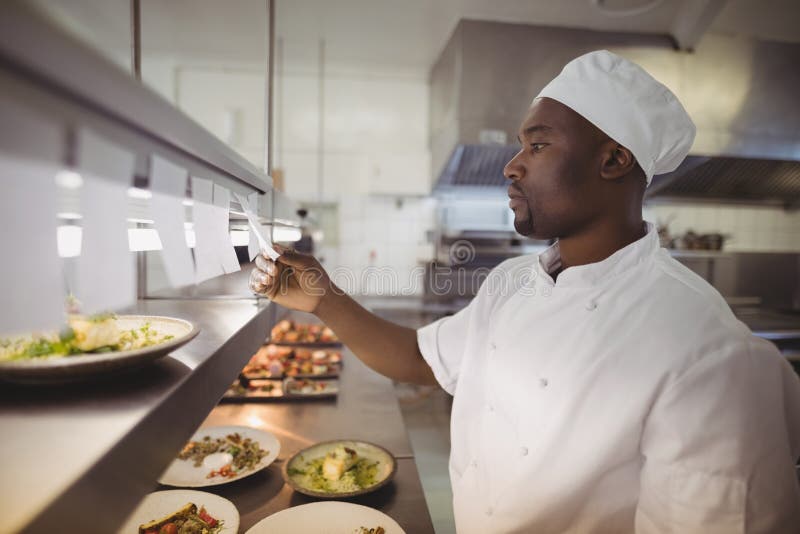 Chef Looking at an Order List in the Commercial Kitchen Stock Photo ...