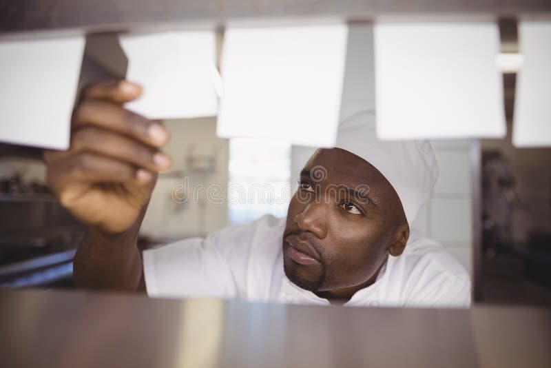 Chef Looking at an Order List in the Commercial Kitchen Stock Photo ...
