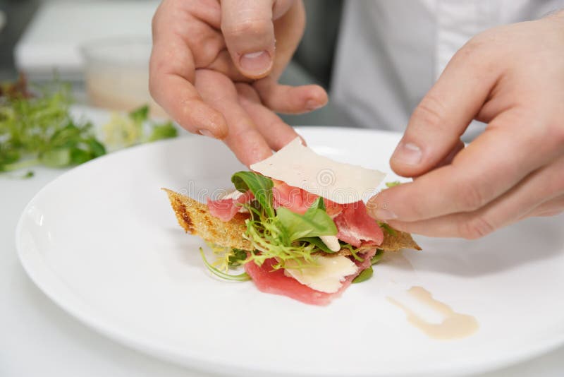 Chef is making appetizer stock photo. Image of cooking - 28610042