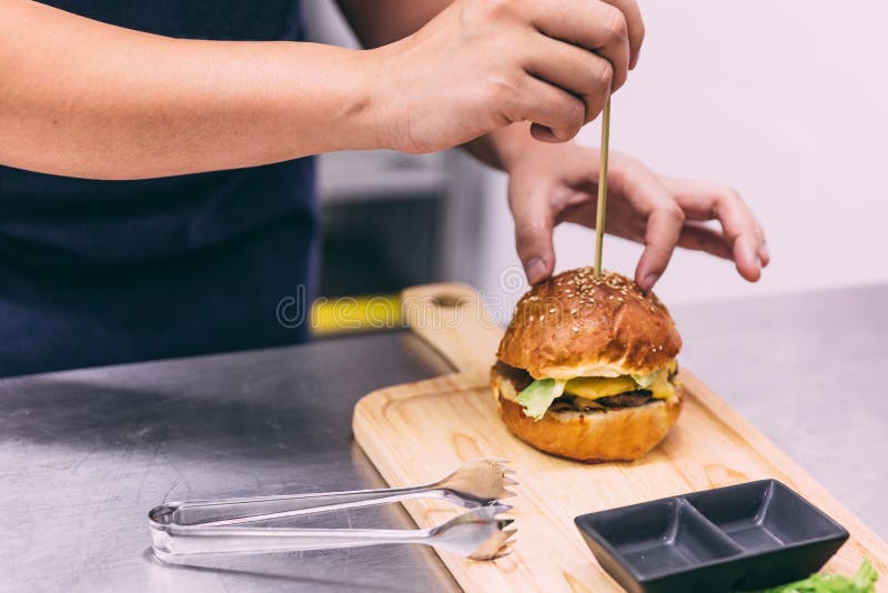 Chef Making a Beef Cheeseburger on Wooden Plate Stock Photo - Image of ...