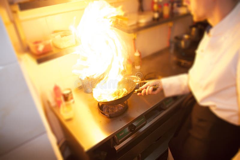 Chef is making flambe stock photo. Image of dishware - 27213740