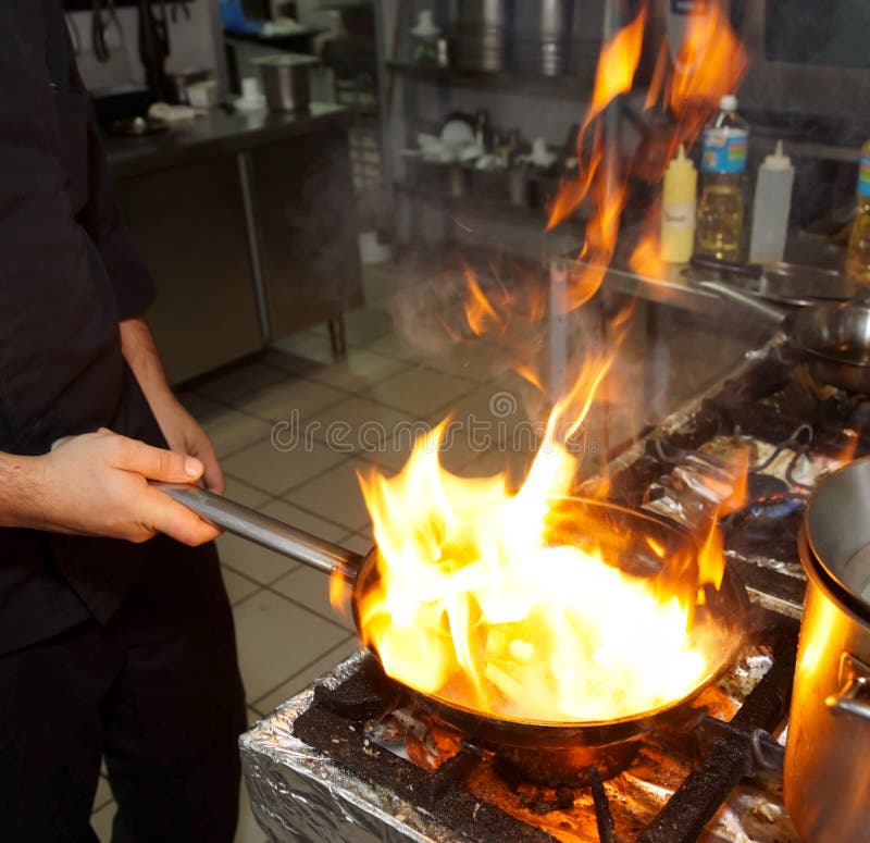 Chef flambe cooking stock image. Image of fire, place - 13153935