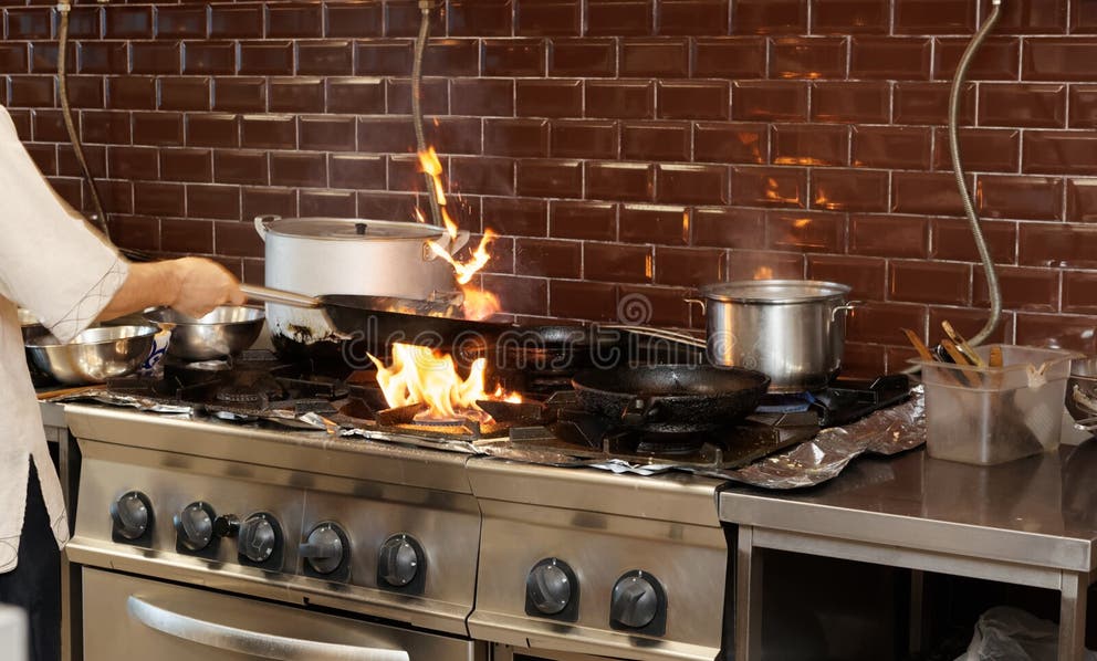 Chef is making flambe dish stock image. Image of fire - 85567977