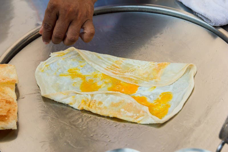 Chef making roti and egg stock photo. Image of delicious - 152196470