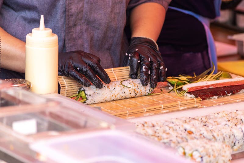 Chef is Making Sushi Outdoor on Open Kitchen. Street Food Festival ... Chef is Making Sushi Outdoor on Open Kitchen. Street Food Festival ...