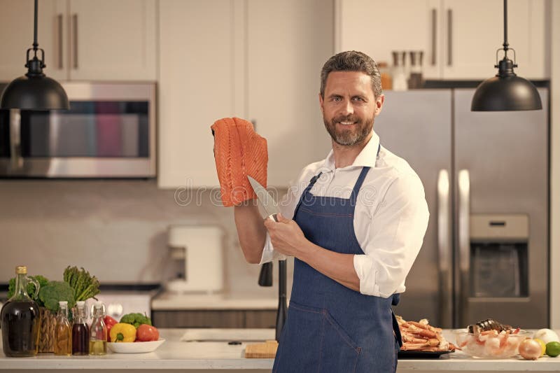Chef Man Cooking Fish in the Kitchen. Photo of Chef Man Cooking Fish ...