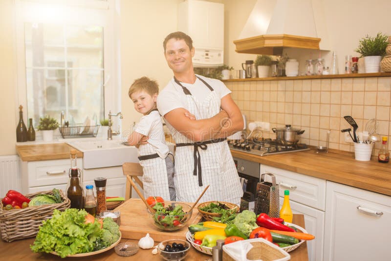Chef Man Cooking on the Kitchen with Little Son. Stock Image - Image of ...