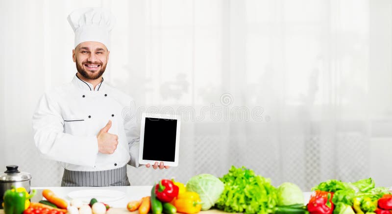 Chef Man Showing Tablet Screen Gesturing Thumbs-Up Standing in Kitchen ...