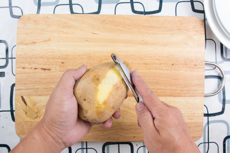 Chef peeling potato stock photo. Image of concept, chef - 117511770