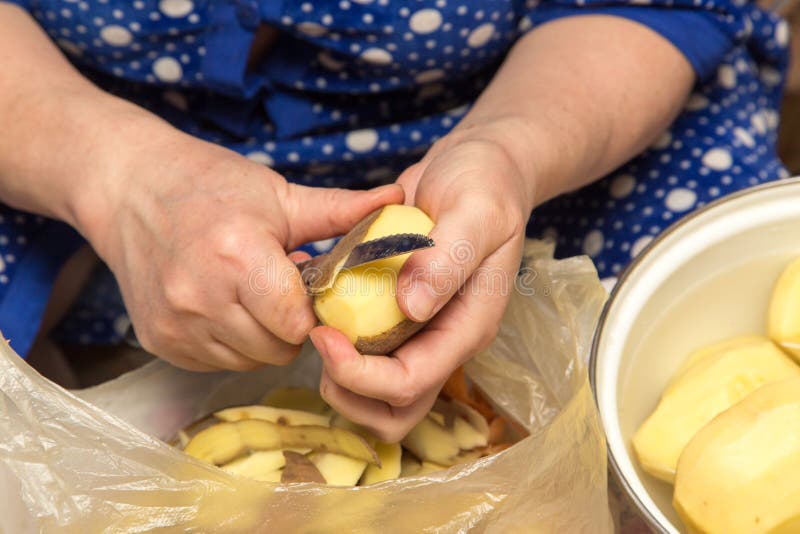 Chef peeling potatoes stock photo. Image of peeling - 106388730