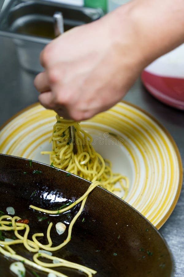 Chef Plating Spaghetti Aglio E Olio with Tongs Stock Photo - Image of ...