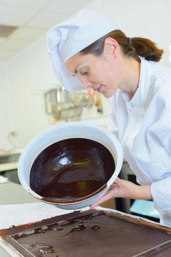 Pouring chocolate to bake stock image. Image of chocolate - 118383621