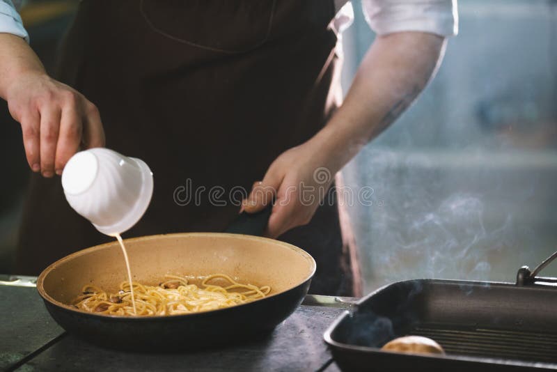 Pouring Spaghetti from a Silver Colander into the Wok Stock Image ...