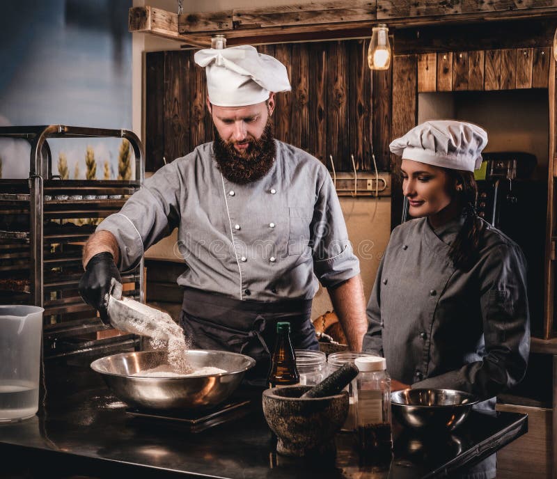 Chef Pours the Flour into a Bowl. Chef Teaching His Assistant To Bake ...