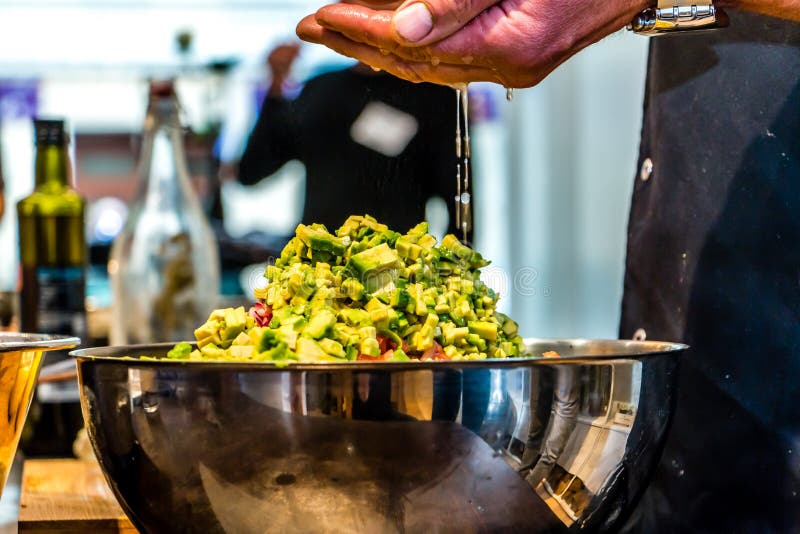 Chef pours lemon juice into the pot while cooking, Chef pours lemon ...