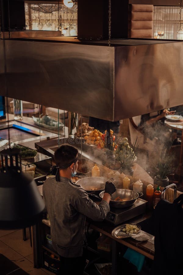 Chef Prepares an Asian Dish in the Kitchen in a Restaurant Top View ...