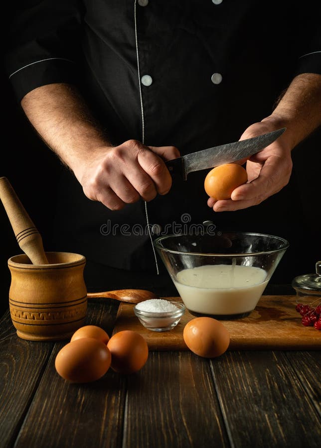 A Chef Prepares an Egg Omelette with Milk in the Kitchen of a Breakfast ...