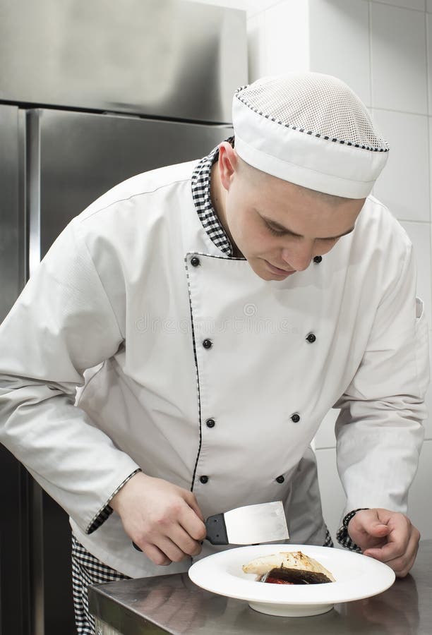 Chef prepares a meal stock image. Image of standing, plate - 45023959