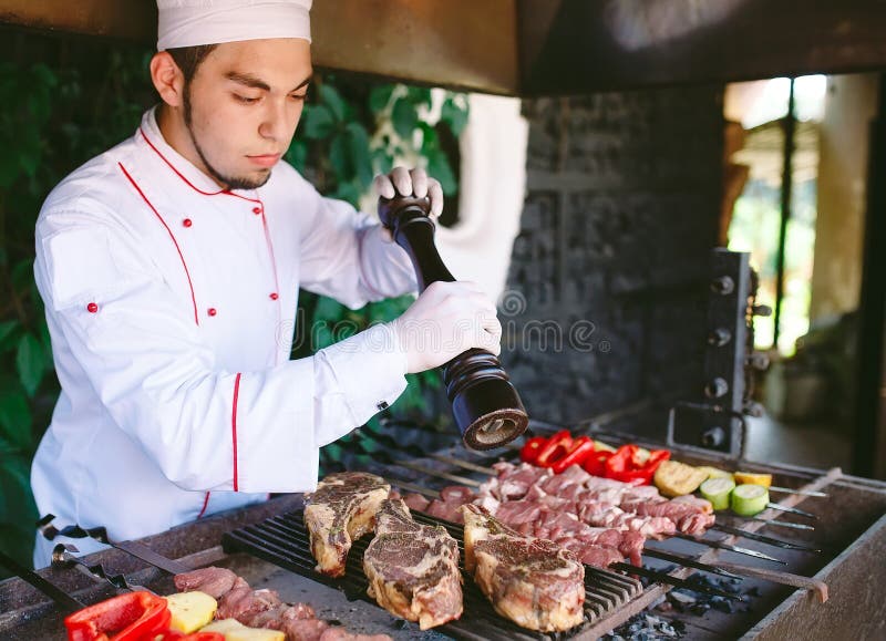 The Chef Prepares Meat on the Barbecue. Stock Image - Image of ...