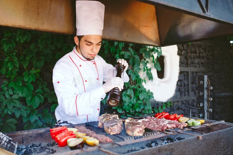 The Chef Prepares Meat on the Barbecue. Stock Photo - Image of hand ...