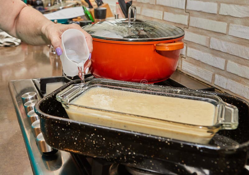 Chef Prepares Pie for Baking in Water Bath. Pours Water into the Dishes ...