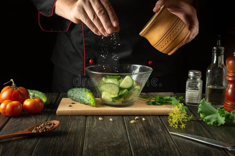 The Chef Prepares a Vegetable Salad in the Restaurant Kitchen. Adding ...