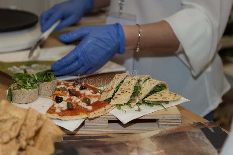 A Chef Preparing Appetizers Based on Pieces of Pizza and Stuffed ...