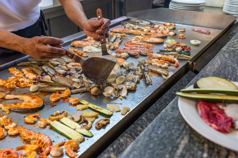 Chef Preparing Assortment of Seafood on Frying Table in Kitchen Stock ...