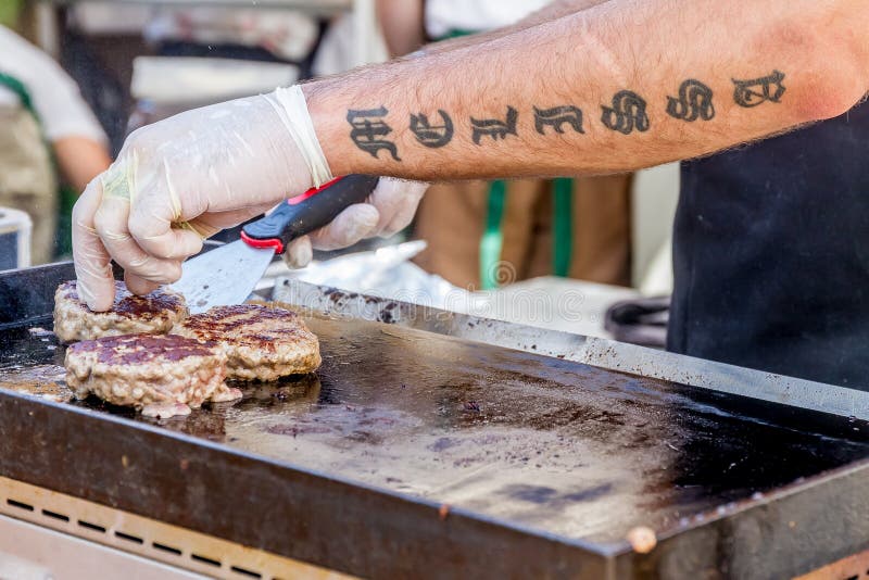 Chef preparing a burger stock photo. Image of candid - 77949886