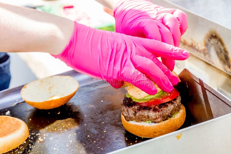 Chef preparing a burger stock photo. Image of bistro - 77950062