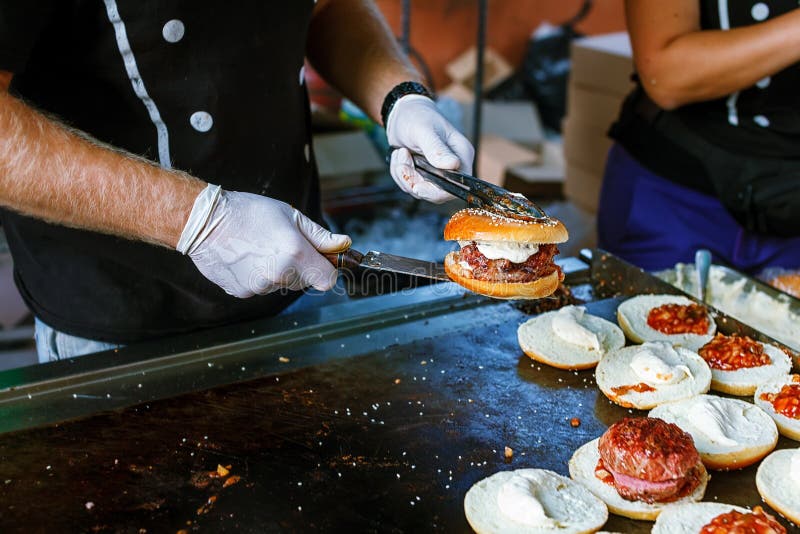Chef Preparing Burgers at the Barbecue Outdoors Stock Image - Image of ...